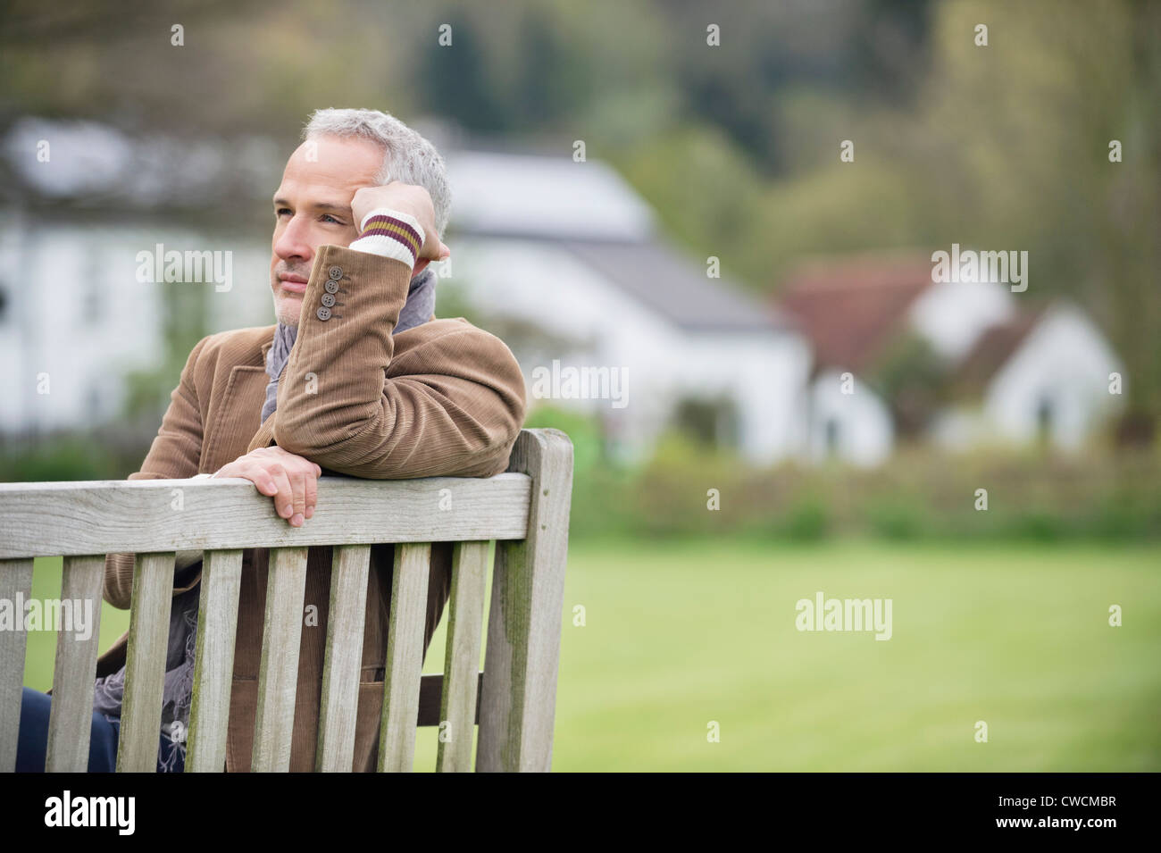 Man sitting on a bench and thinking in a park Stock Photo - Alamy