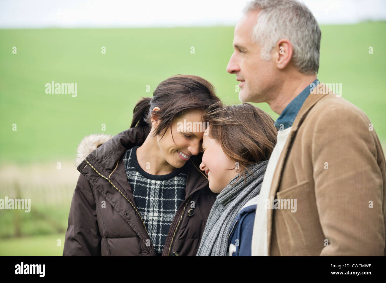 Happy family in a field Stock Photo - Alamy