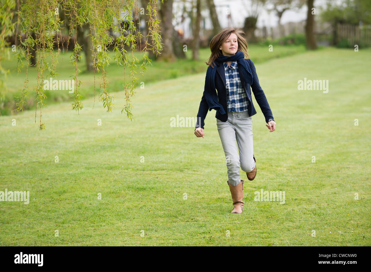 Girl running in a field Stock Photo - Alamy