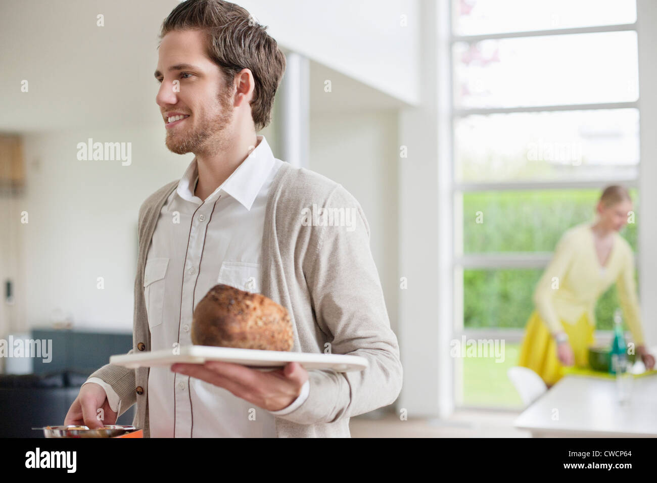 Man carrying bread on a tray Stock Photo - Alamy