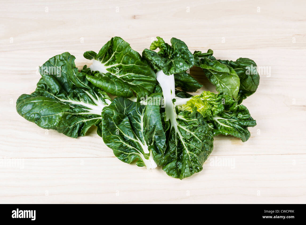 Fresh Chinese choy vegetable on White Ash wood background Stock Photo ...