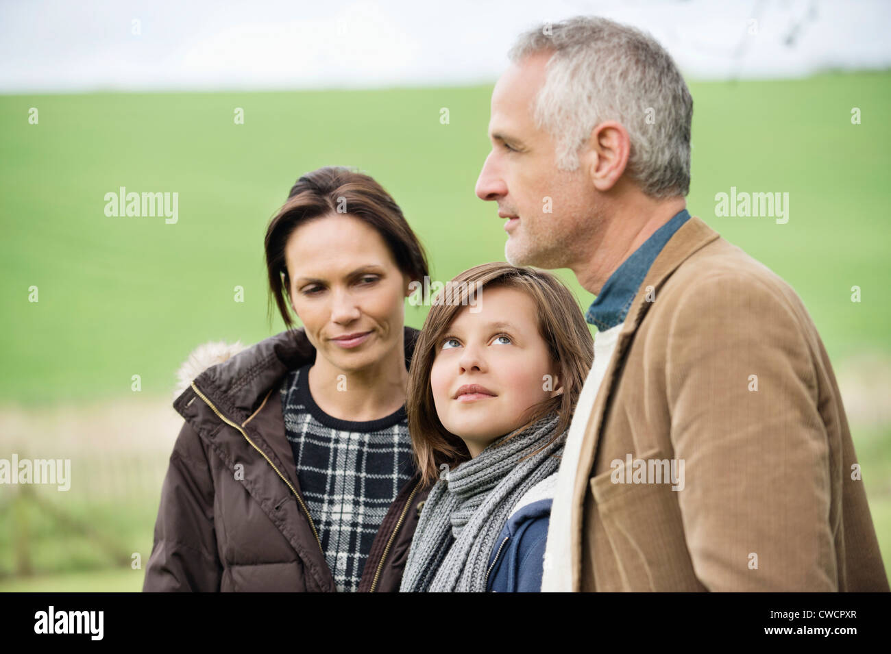 Happy family in a field Stock Photo - Alamy