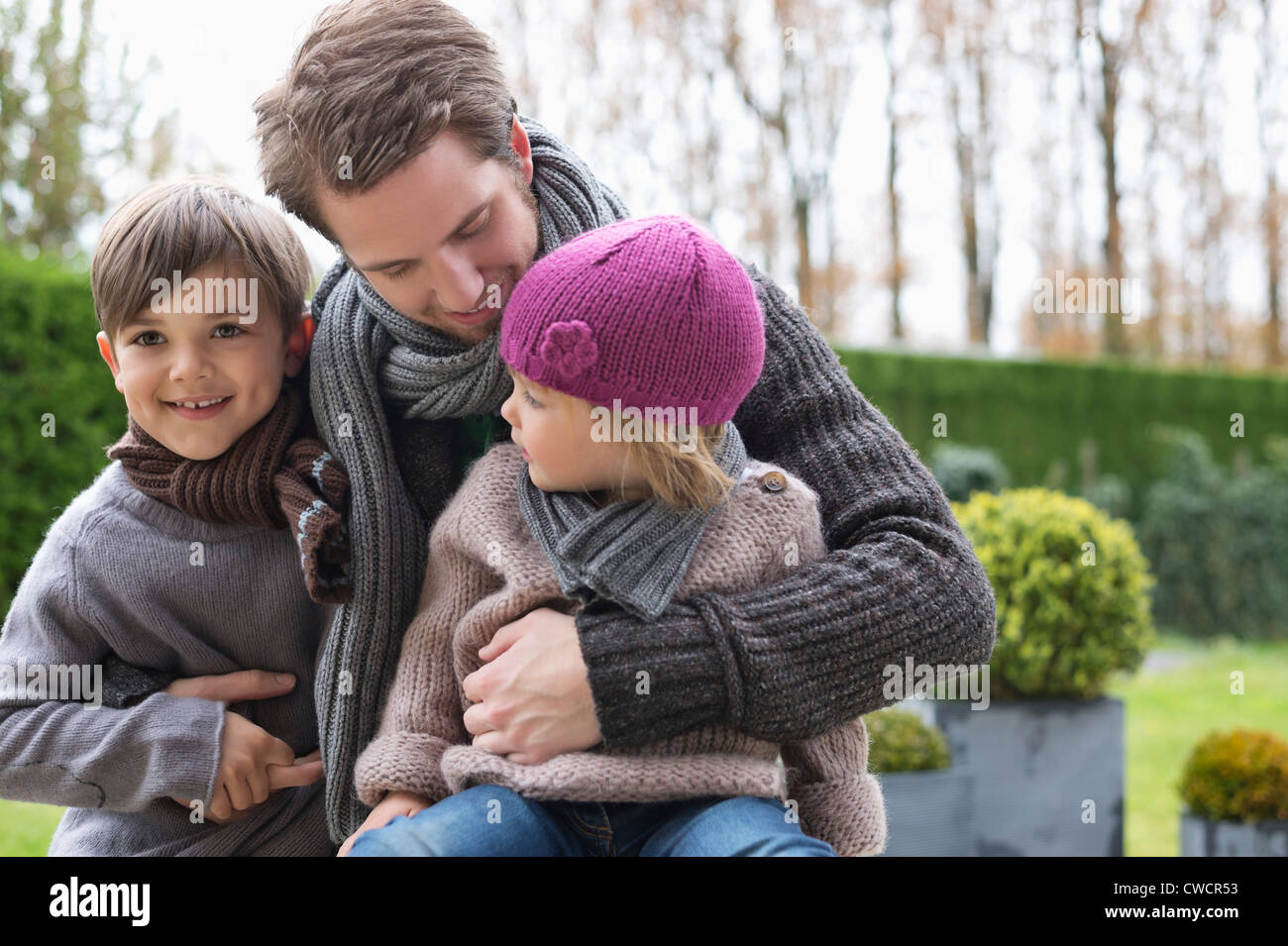 Man hugging his two children Stock Photo - Alamy