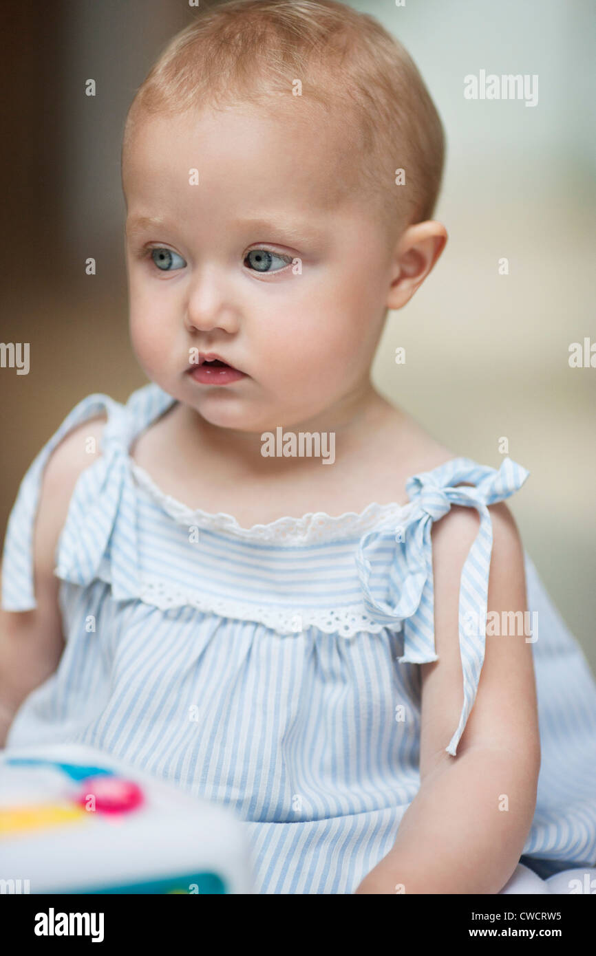 Baby girl with a musical block toy Stock Photo - Alamy