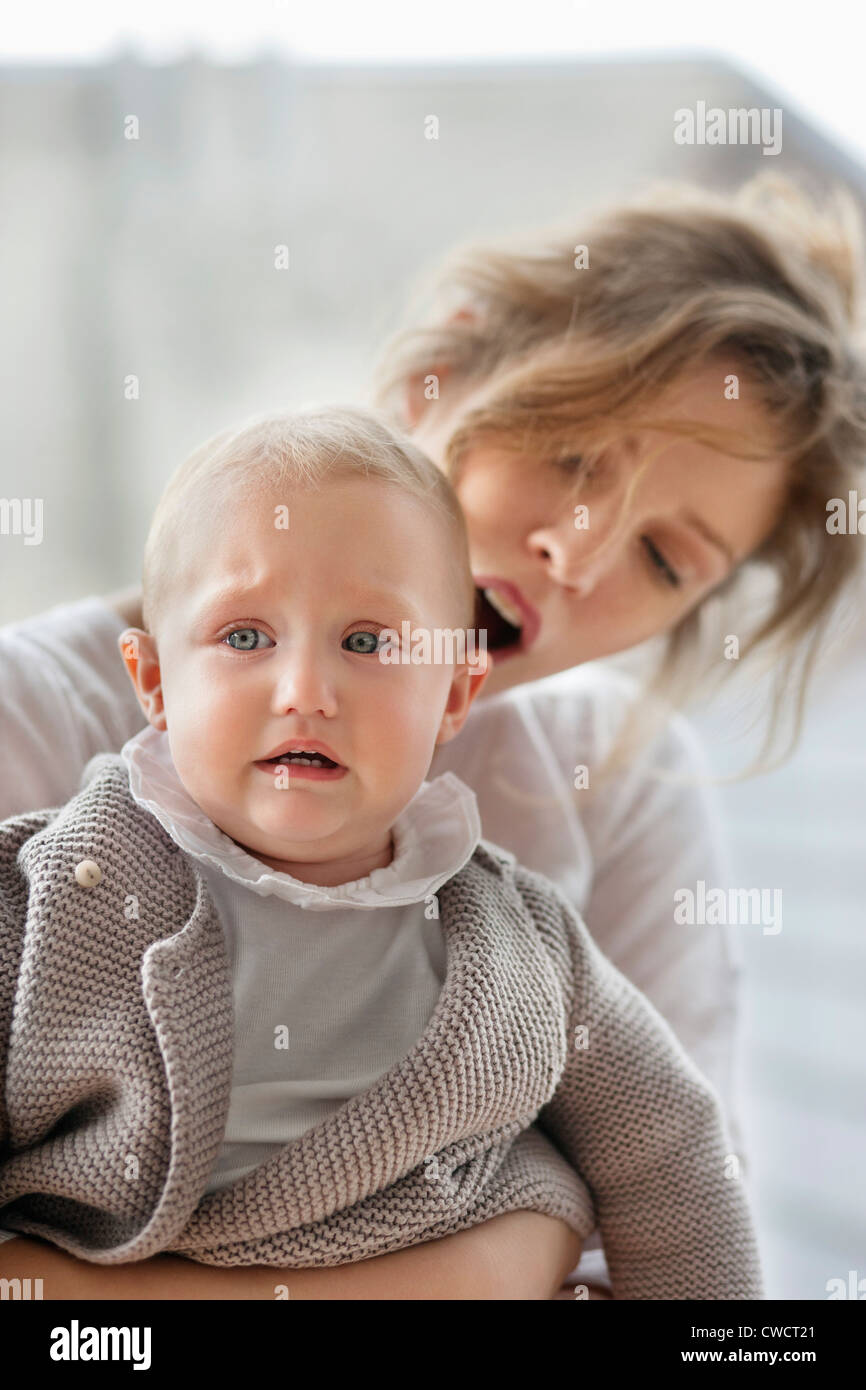Woman consoling her crying baby Stock Photo - Alamy