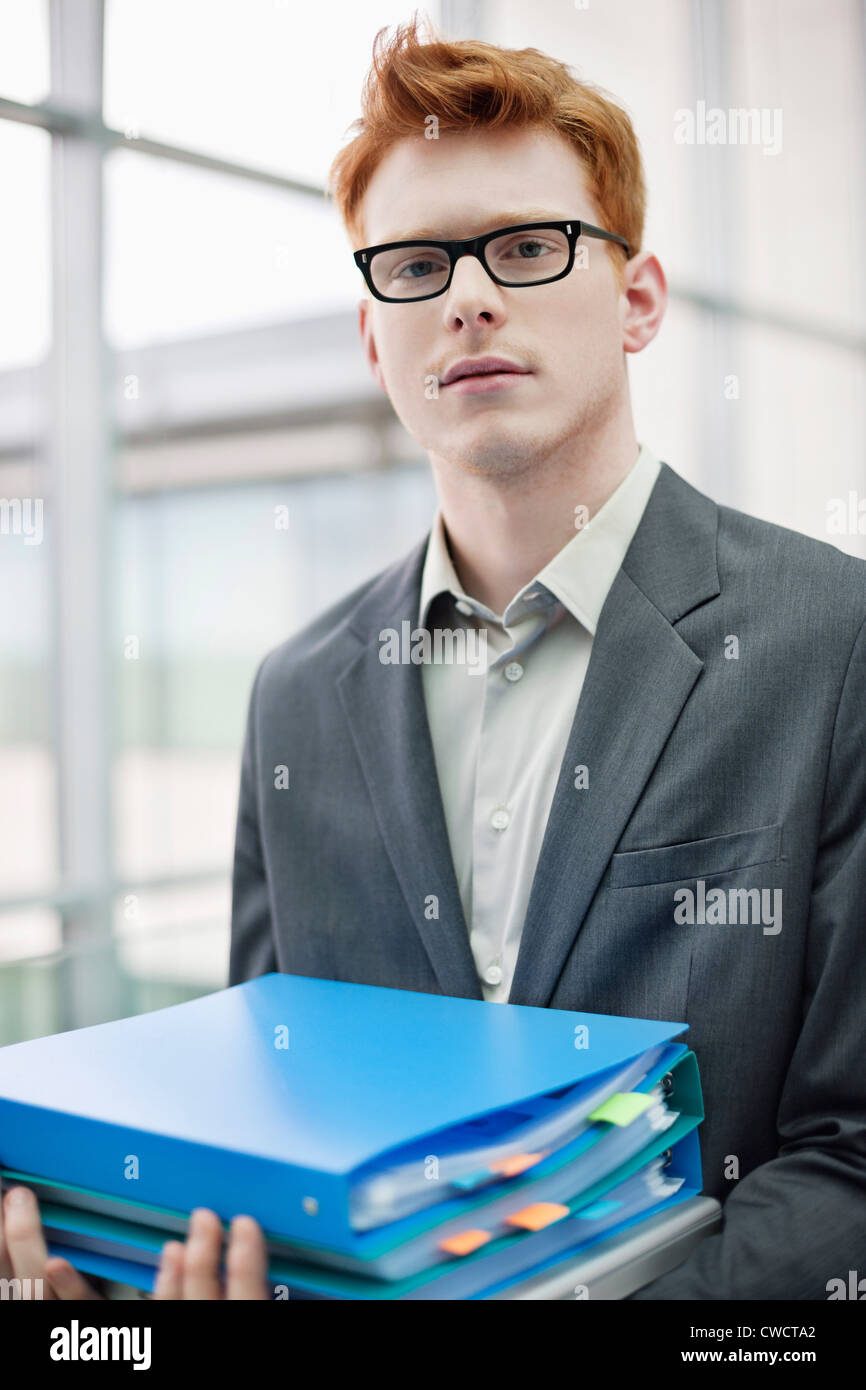 Portrait of a businessman holding files in an office Stock Photo - Alamy
