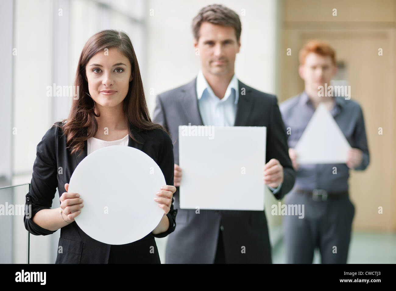 Business executives holding blank placards in an office Stock Photo - Alamy