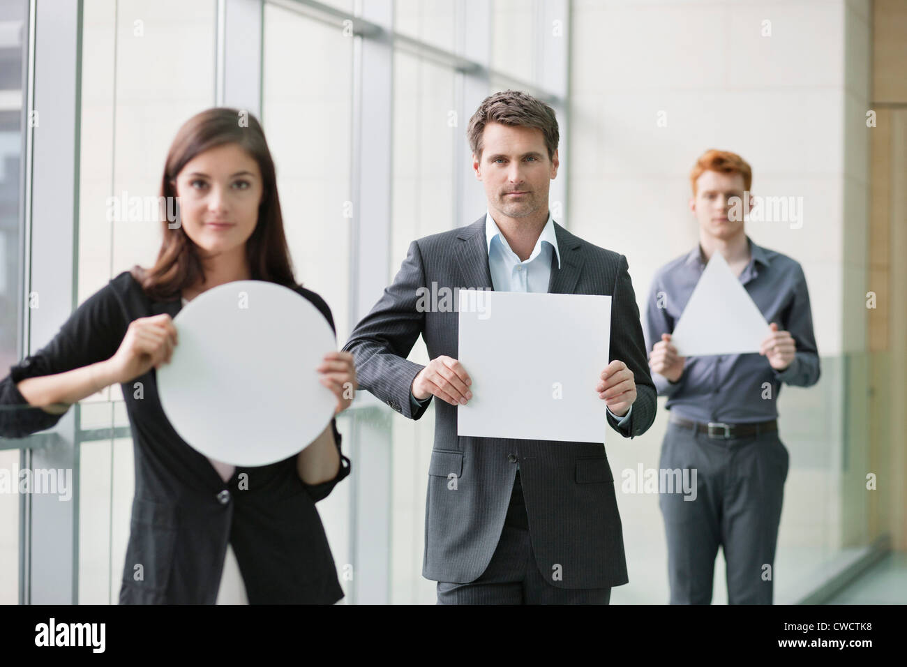 Business executives holding blank placards in an office Stock Photo - Alamy