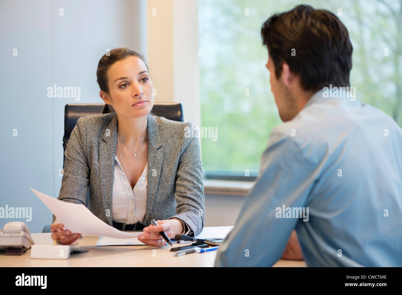Business executive discussing with her client Stock Photo - Alamy