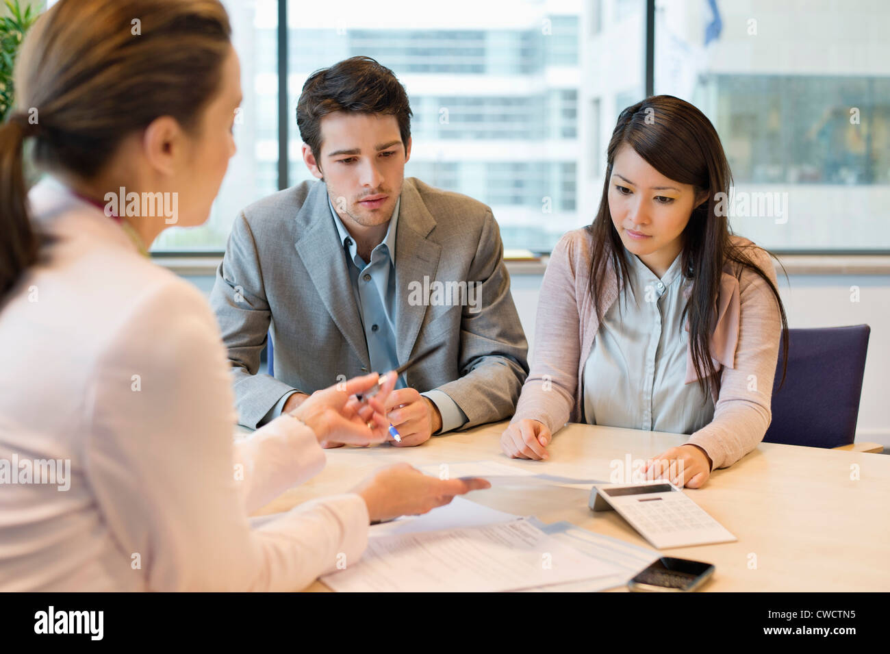 Business executive discussing with her clients Stock Photo - Alamy
