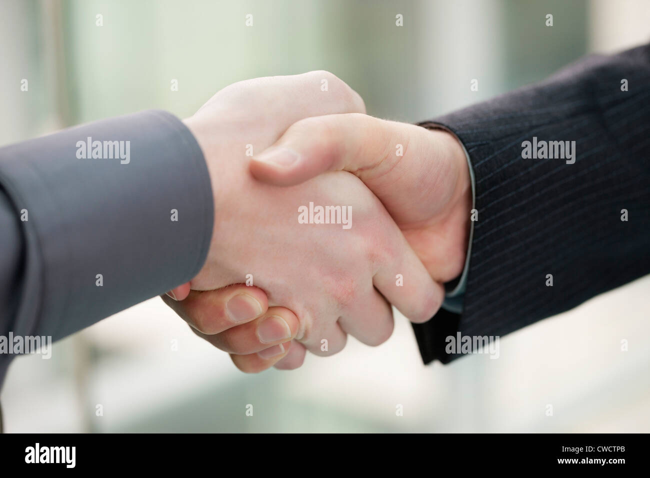 Close-up of businessmen shaking hands in an office Stock Photo - Alamy