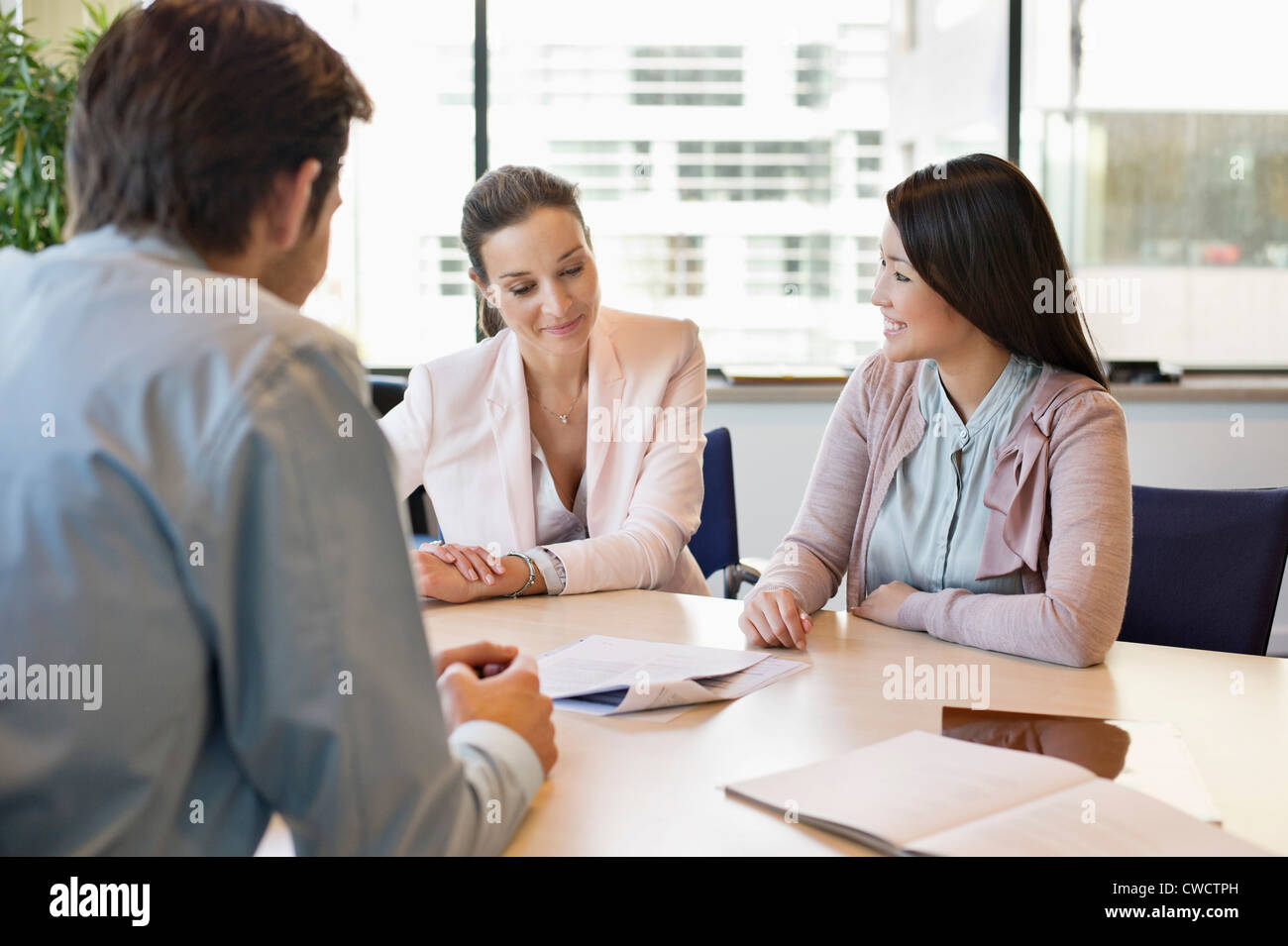 Business executive discussing with his clients Stock Photo - Alamy