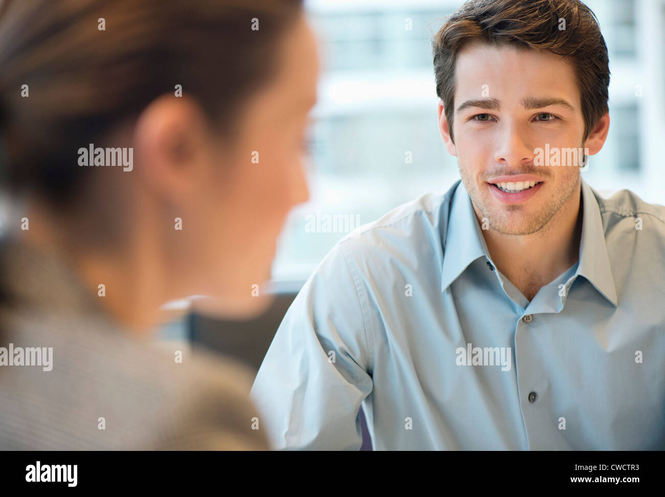 Business executive discussing with her client Stock Photo - Alamy
