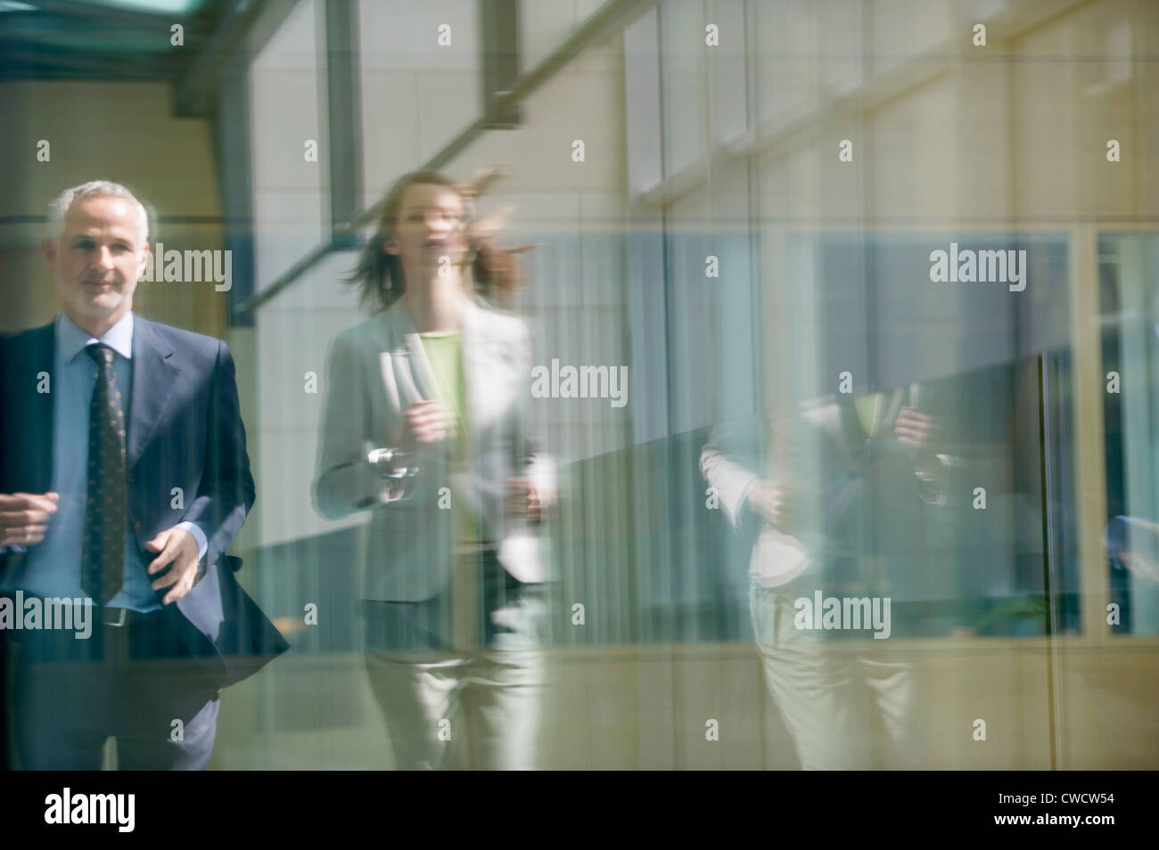 Two business executives running in the corridor Stock Photo - Alamy