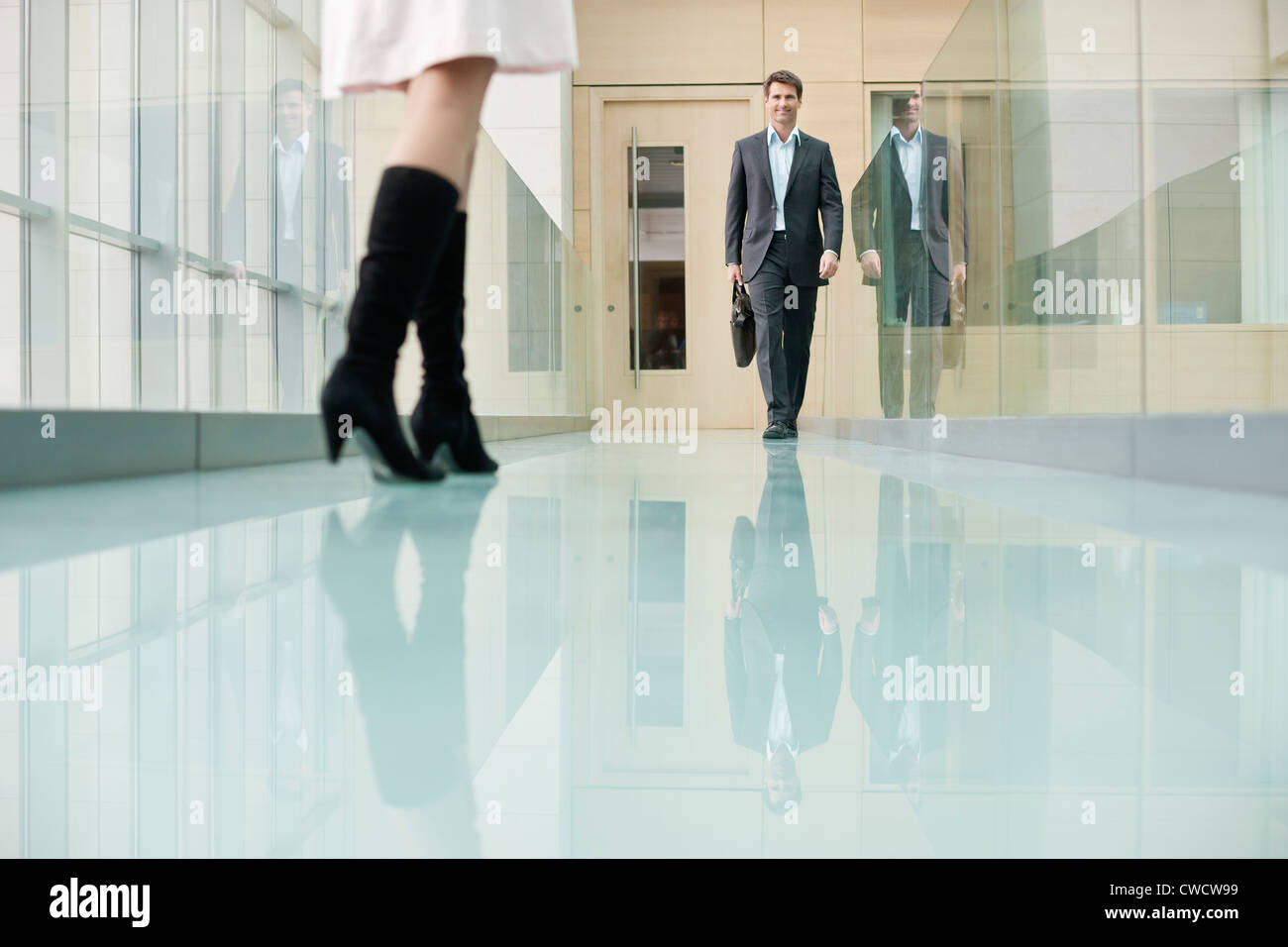Business executives walking in a corridor Stock Photo - Alamy