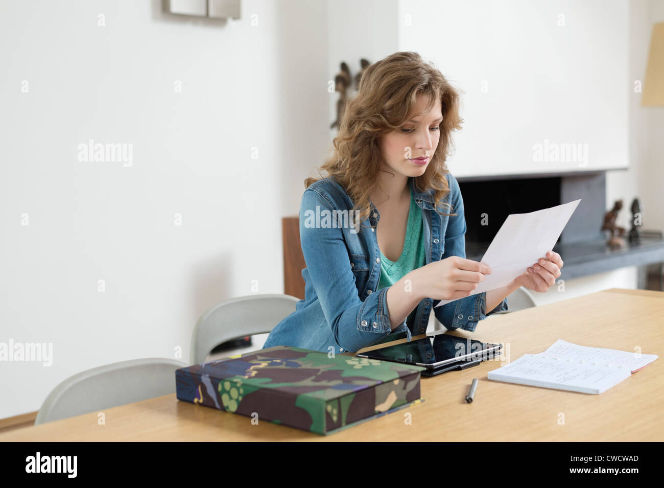 Woman sorting out bills Stock Photo - Alamy
