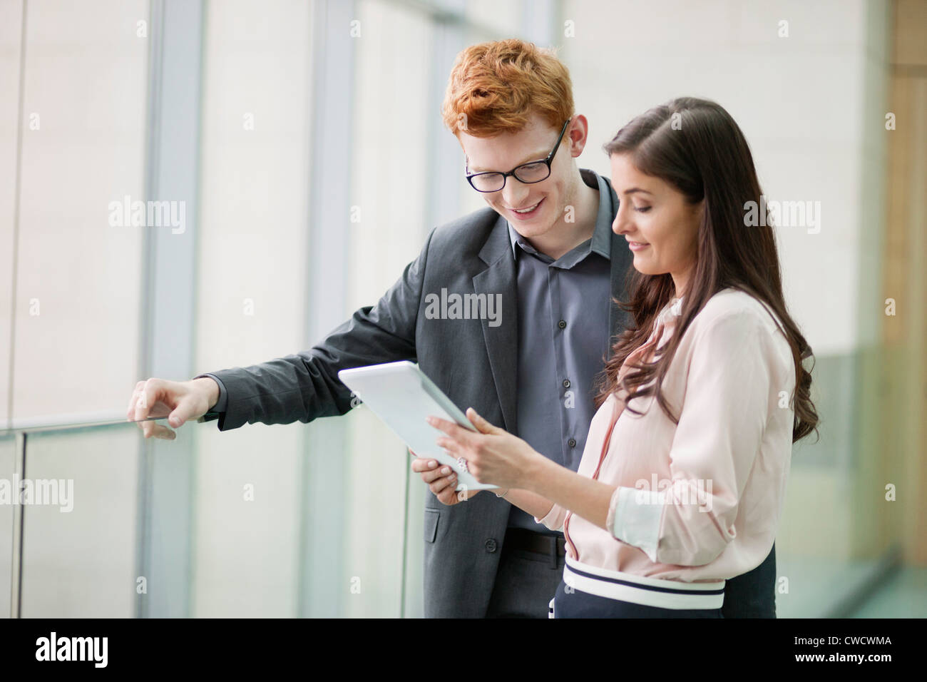 Business executives using a digital tablet in an office Stock Photo - Alamy