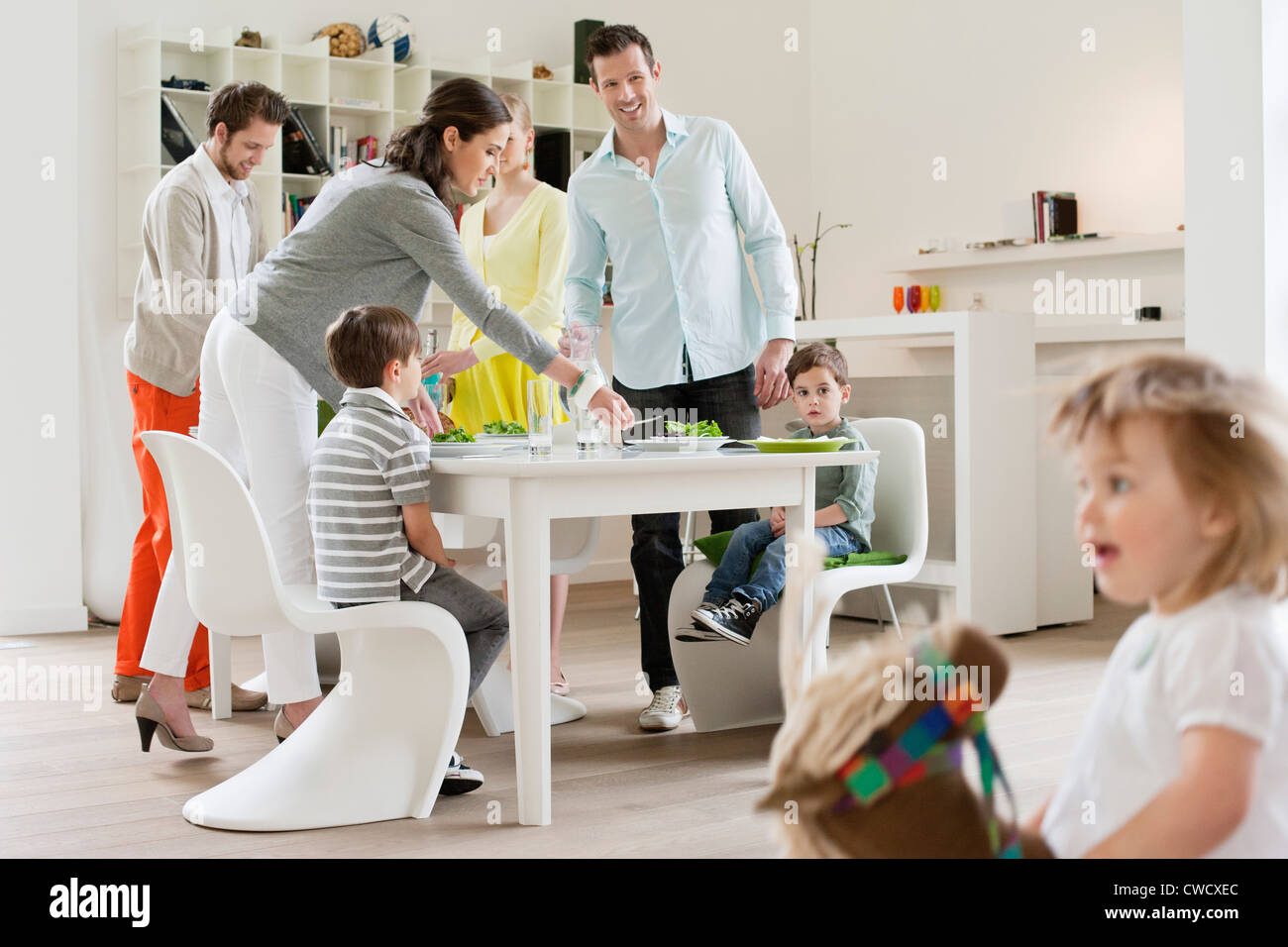 Family at the dining table with guests Stock Photo - Alamy