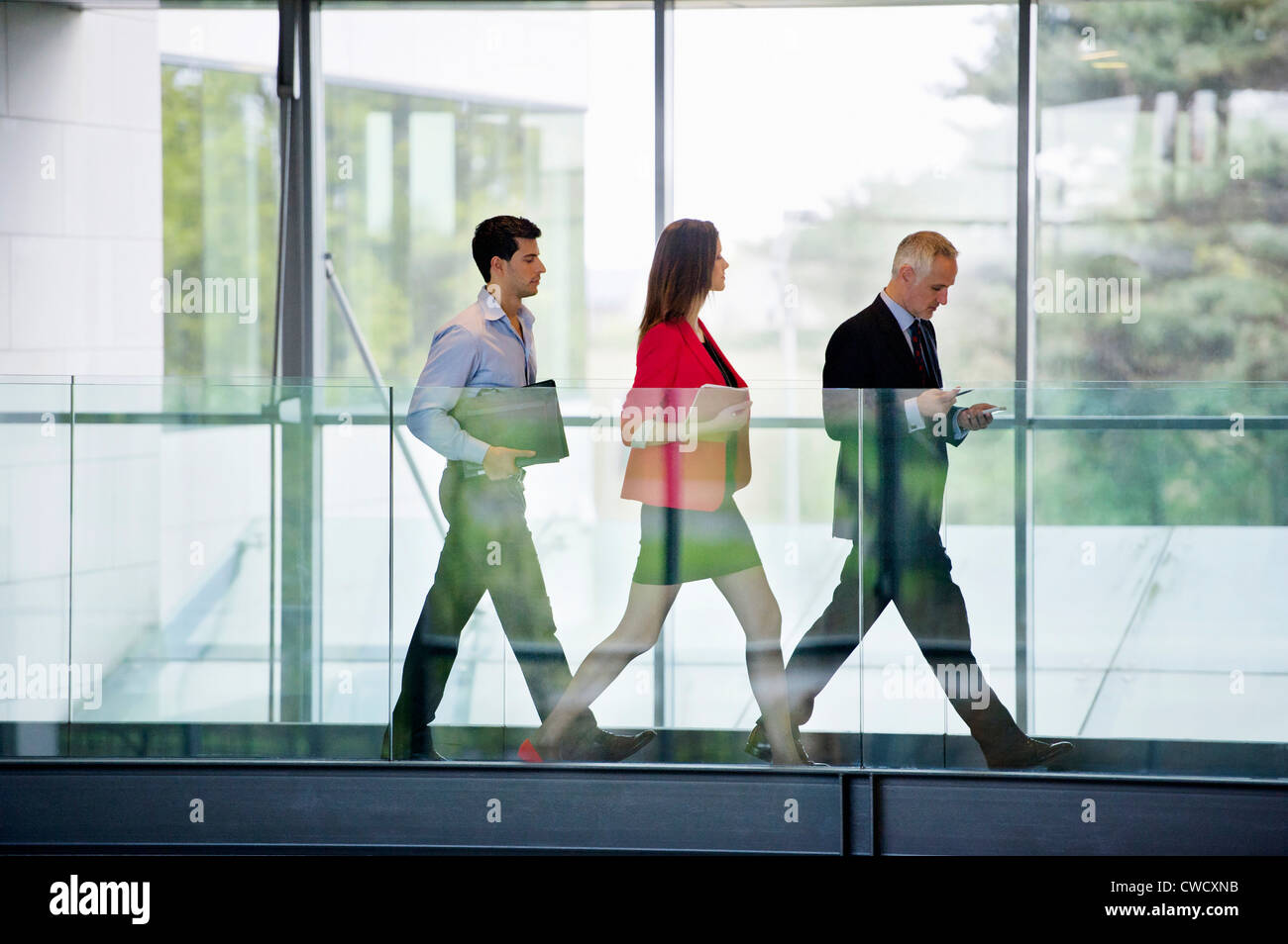 Business executives walking in an office corridor Stock Photo - Alamy