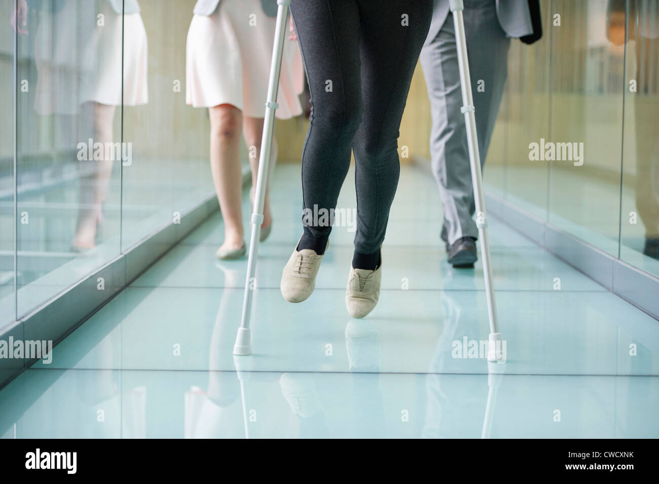 Low section view of three people walking in the corridor Stock Photo ...