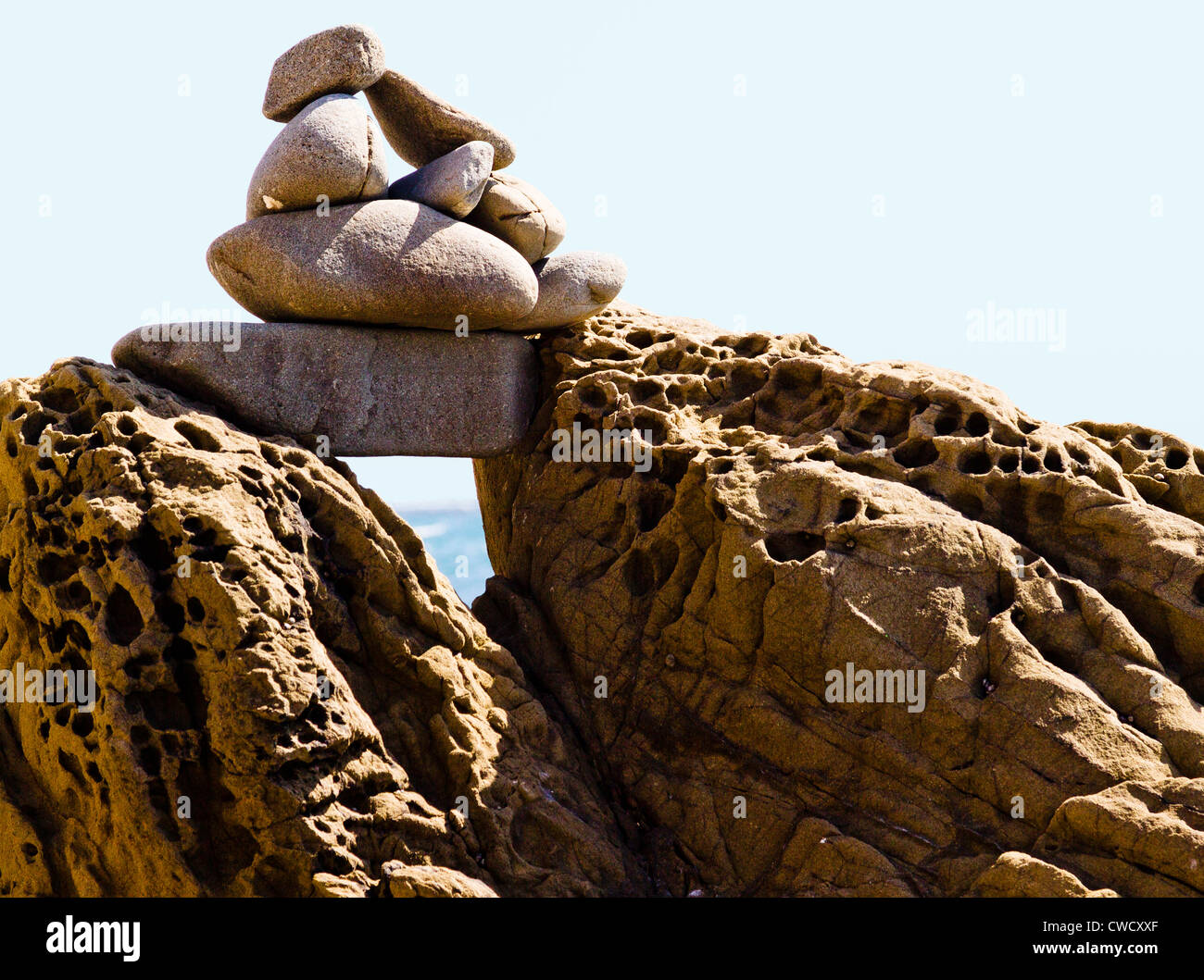 Rocks piled to form sculpture on a beach in Cambria, California Stock ...
