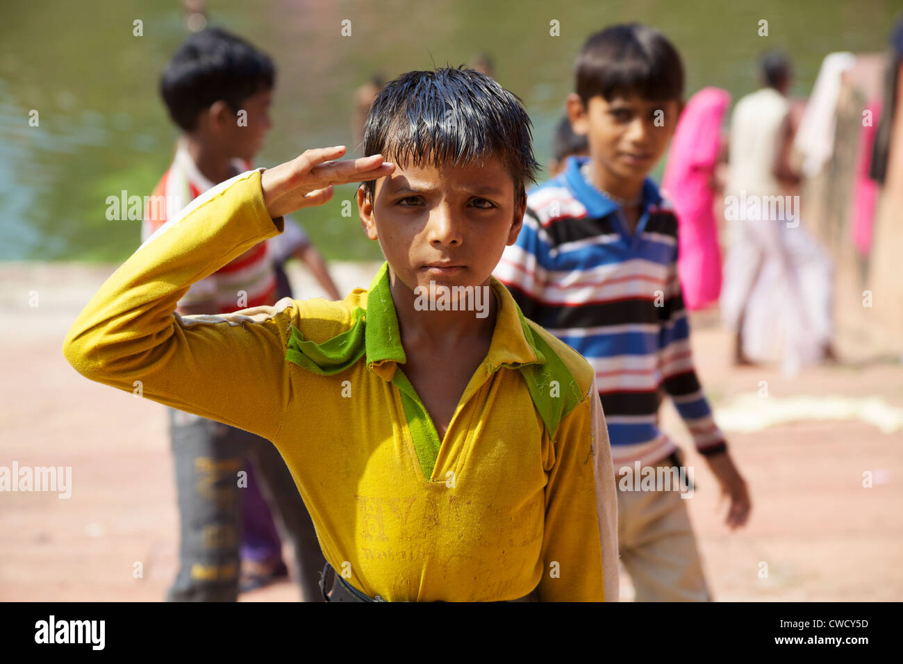 Saluting Indian boy in yellow dress Stock Photo - Alamy