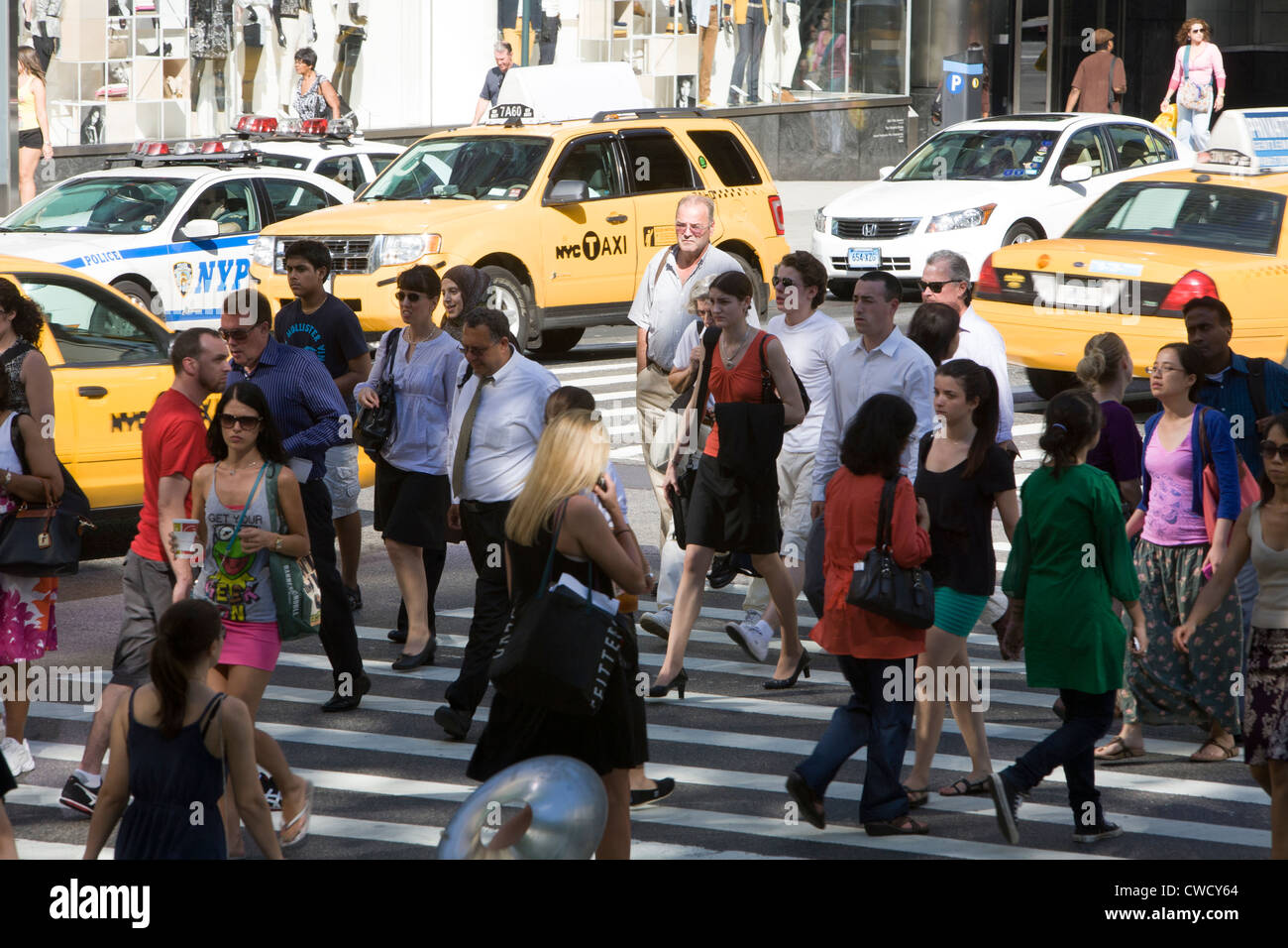 Hot summer day on the always crowded 5th Avenue in Midtown Manhattan ...