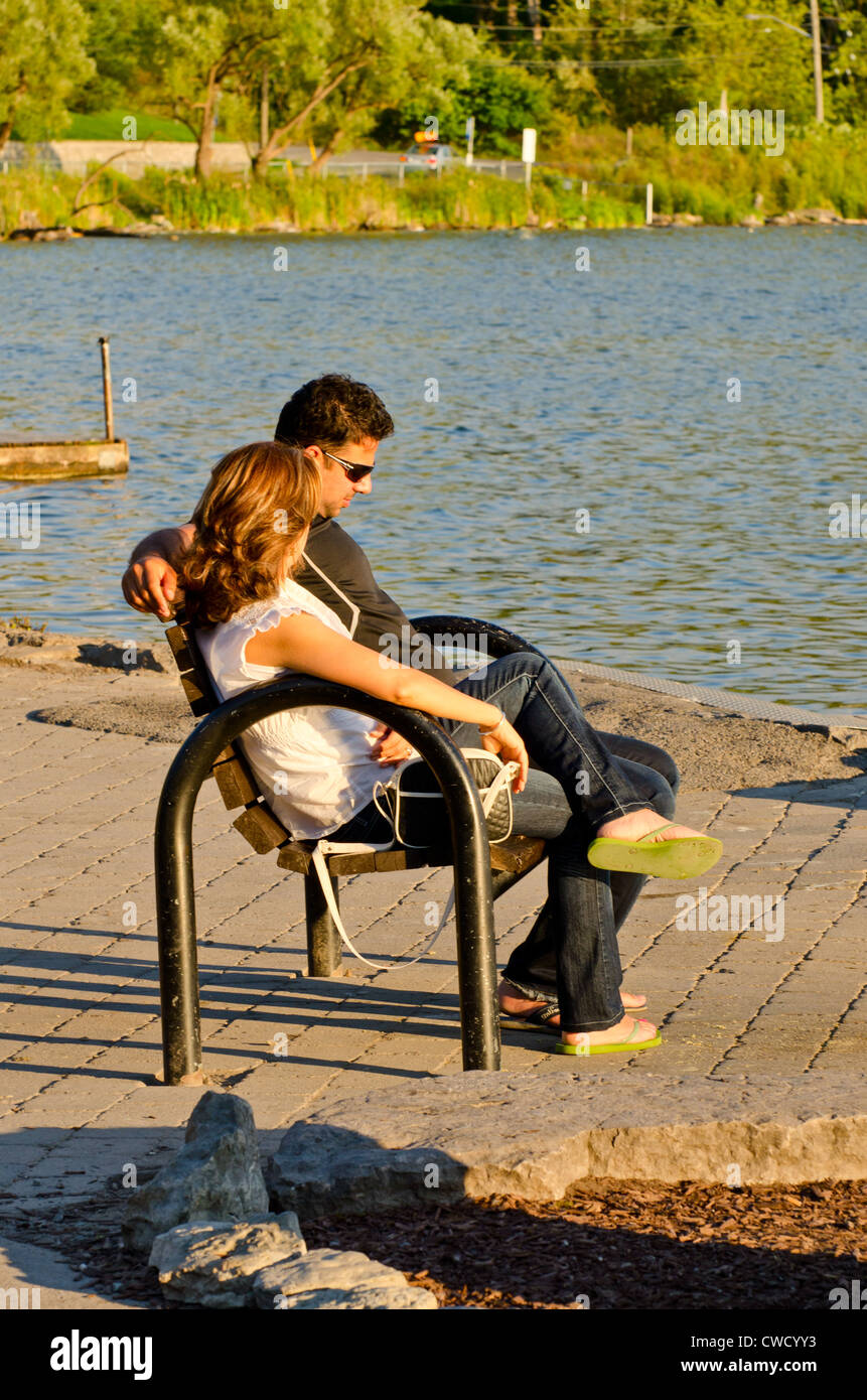 Young couple on a bench Stock Photo - Alamy
