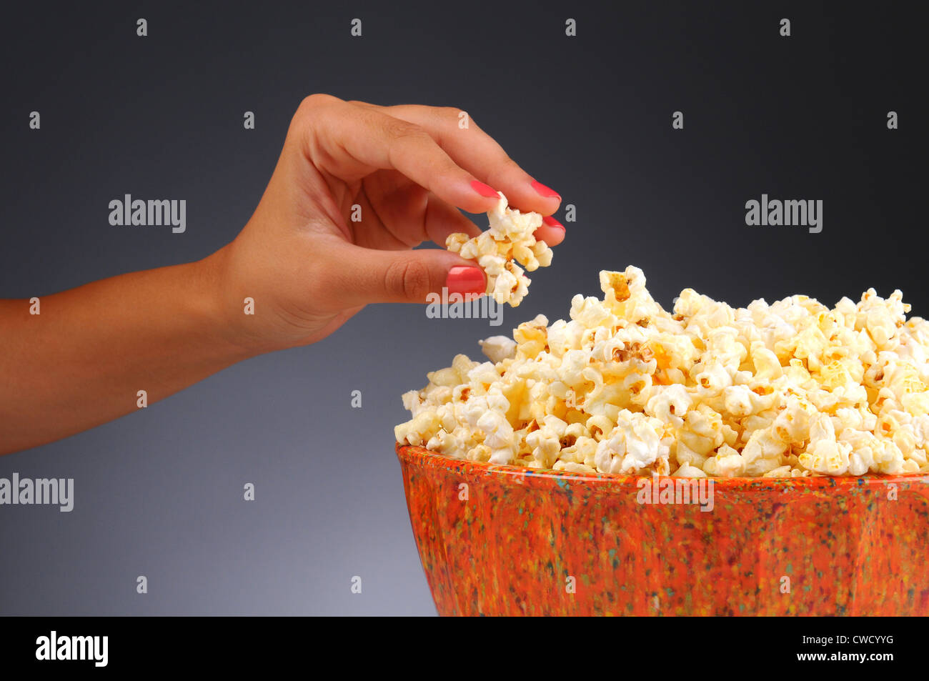 Hand reaching bowl white popcorn hi-res stock photography and images ...