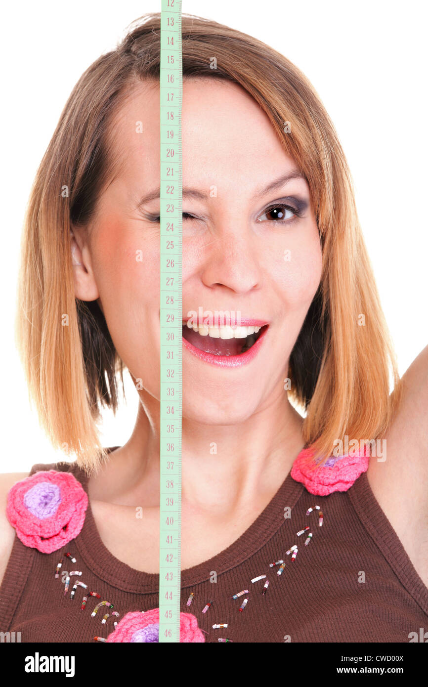 Beautiful young caucasian woman measuring her body with tape, isolated ...