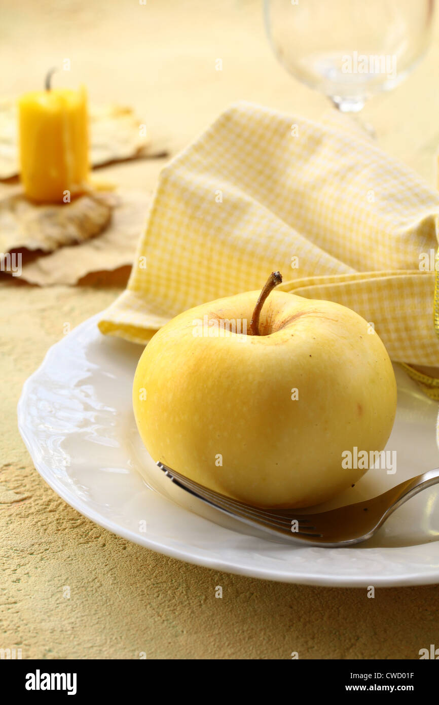 Autumn table setting in yellow with apple Stock Photo - Alamy
