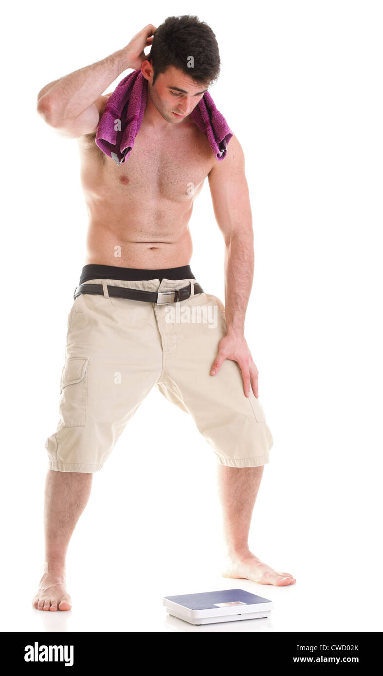 Healthy young man with a weight scale. Isolated over white background ...