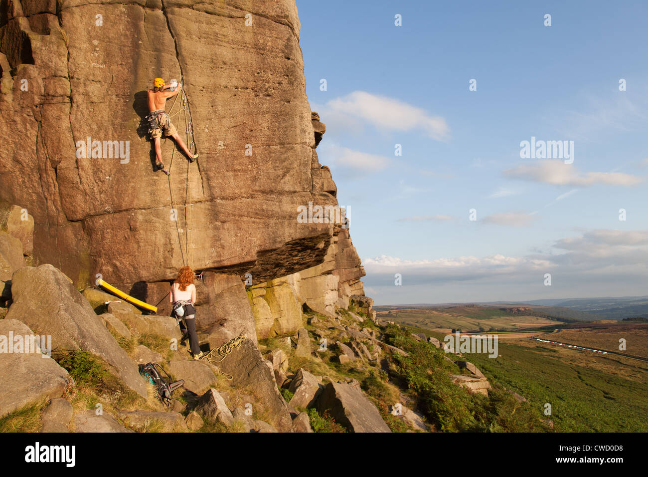 A climber on The Asp, an E3 rock climb on Stanage Edge in Derbyshire,UK ...