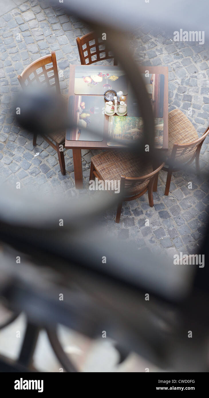 A wooden table of an outdoor restaurant viewed from above through a ...