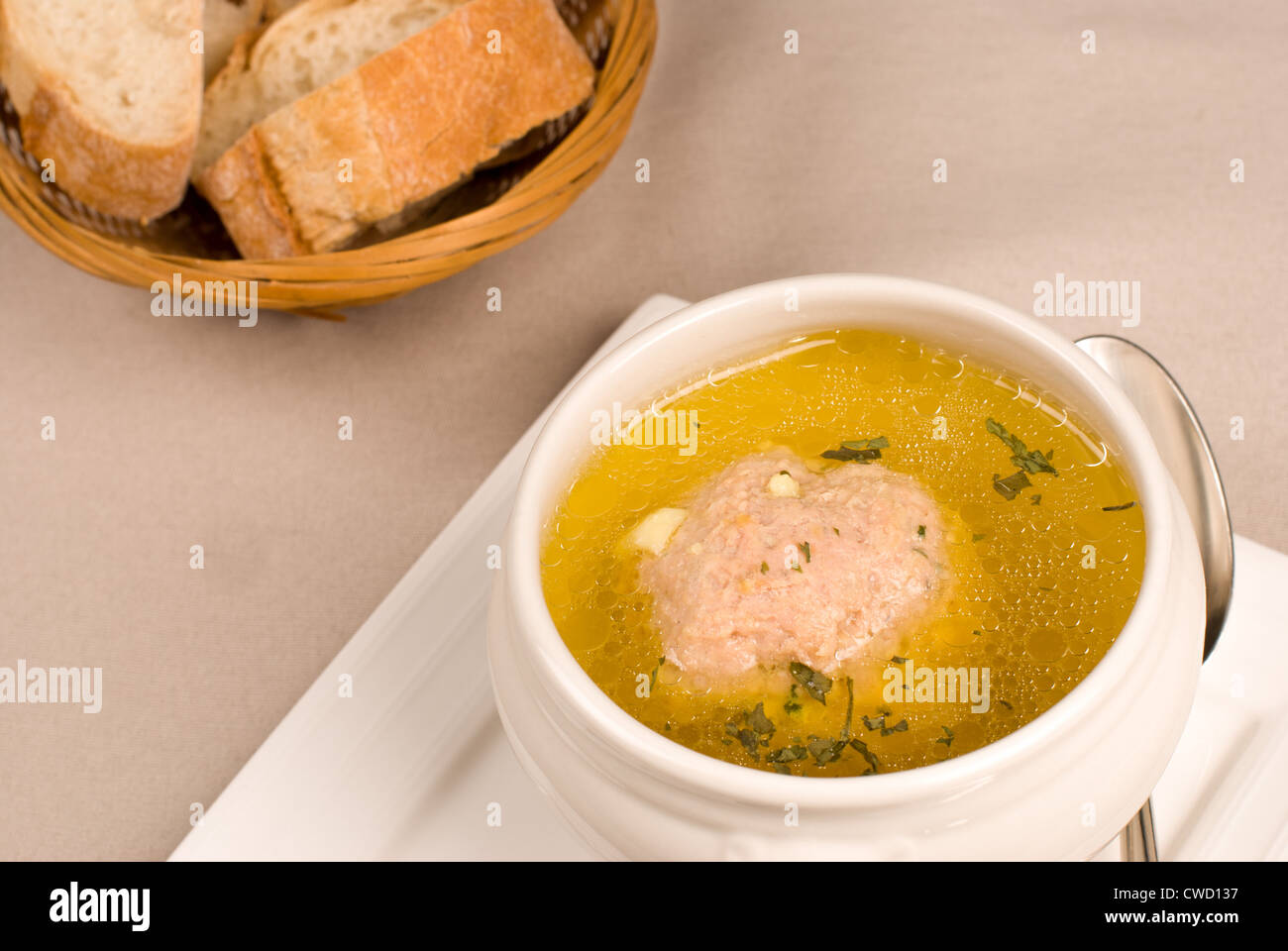 Tasty beef bouillon with meatball served with bread Stock Photo - Alamy