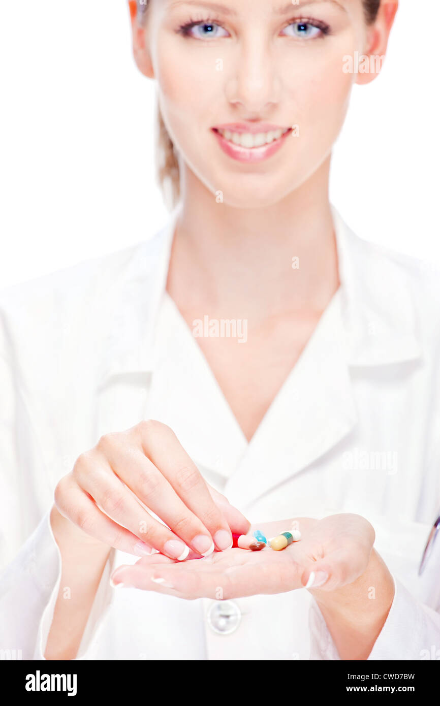 Pretty female nurse holding pills, focus on pills, isolated on white ...