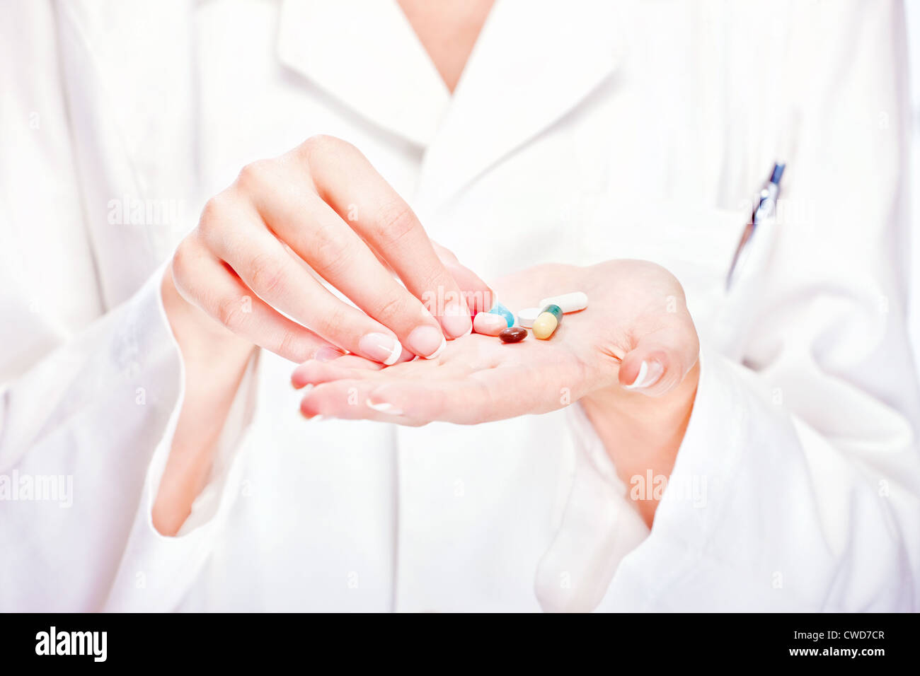 Pills in hands of a female nurse Stock Photo - Alamy