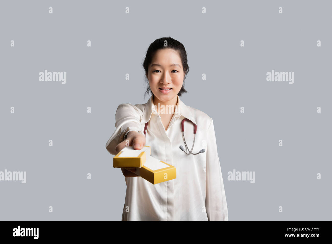 Portrait of a young female doctor giving medicine boxes Stock Photo - Alamy