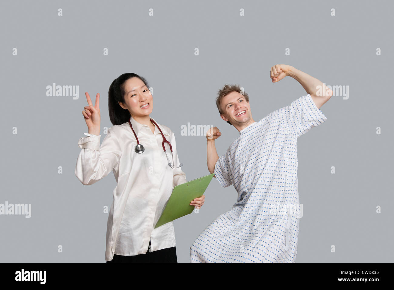 Portrait of doctor gesturing peace sign with patient cheering up Stock ...