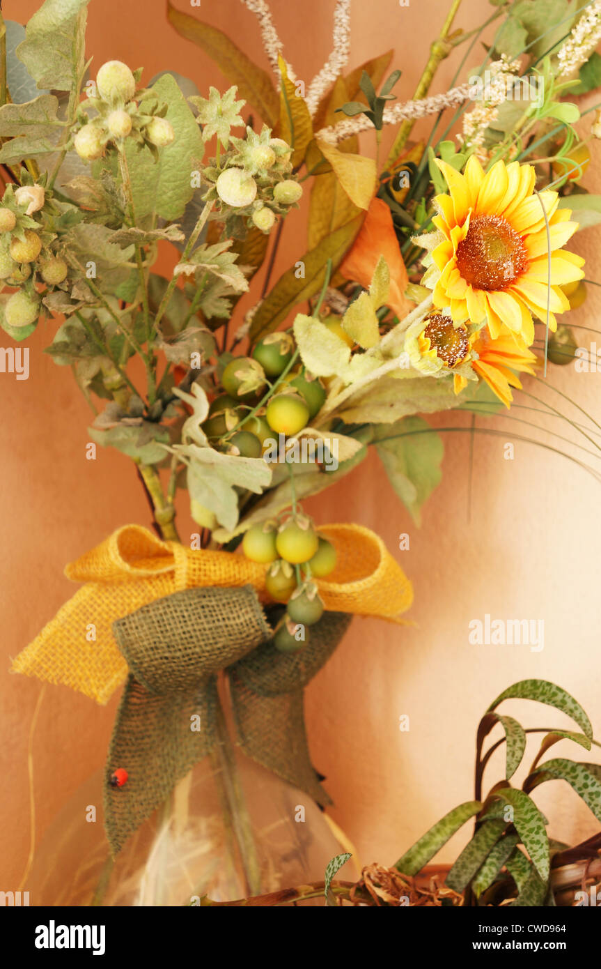 A glass pot with yellow sunflowers and other decorative plants Stock ...