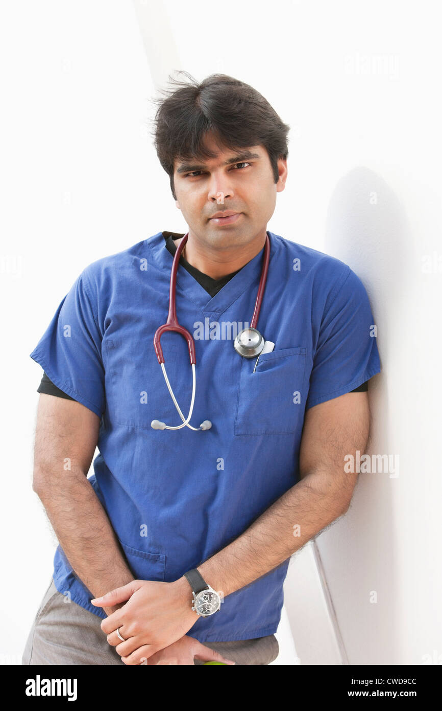 Portrait of an Indian male doctor leaning over white background Stock ...