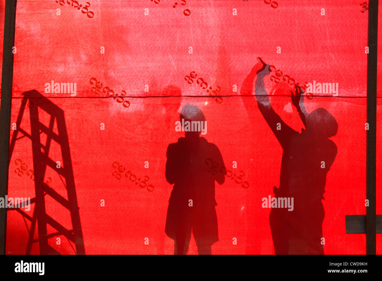 Shadow Play on a red Screen in Rangoon Stock Photo - Alamy