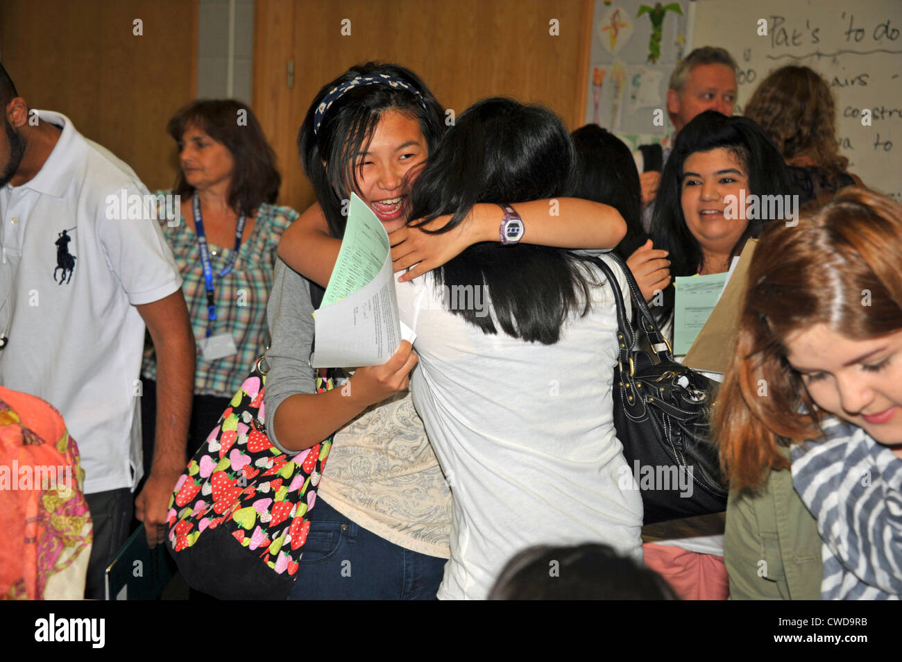Two happy Students hugging each other after receiving their G.C.S.E ...