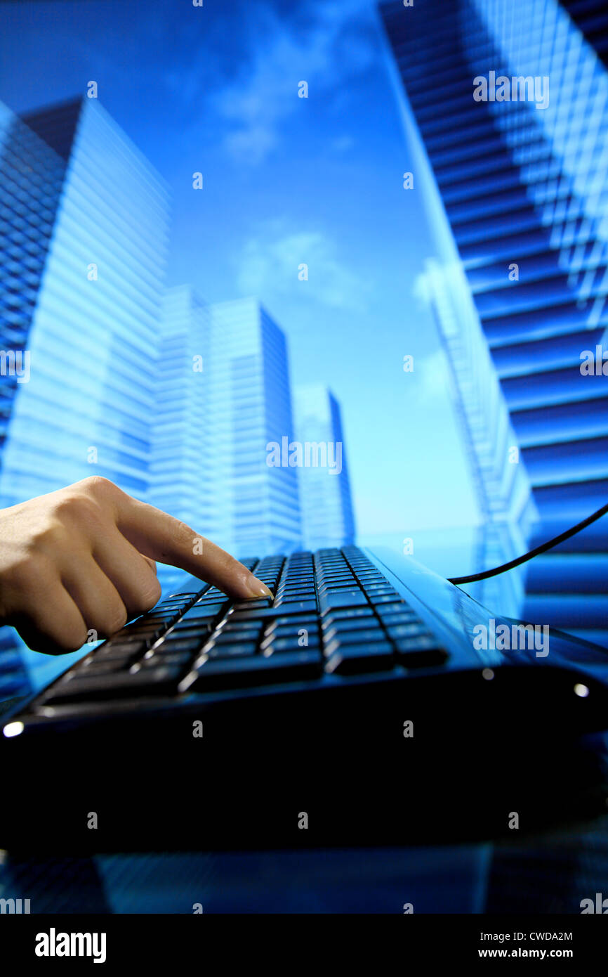 reseller work on keyboard skyscrapers on background Stock Photo - Alamy