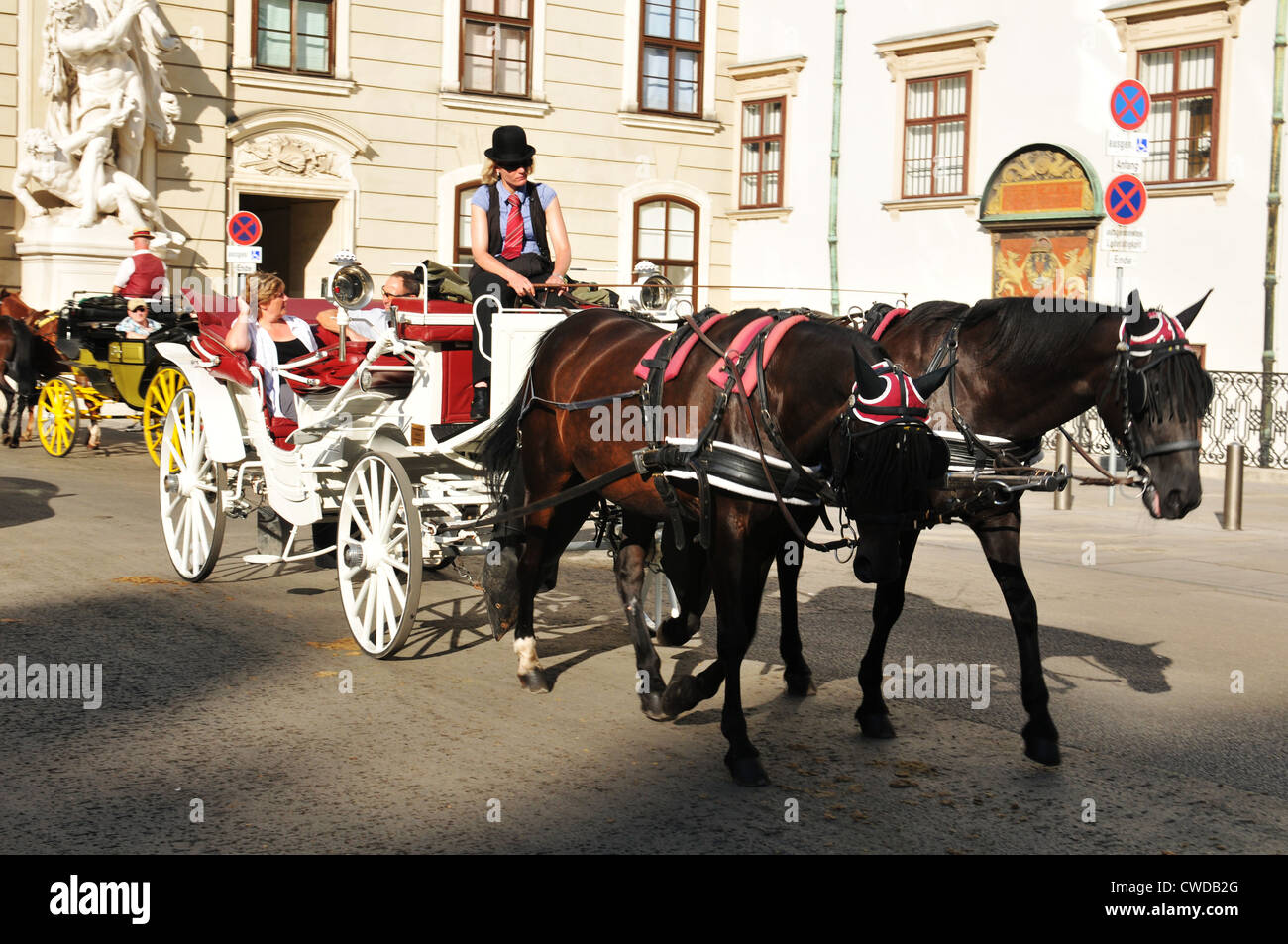 Tourists enjoying sightseeing from traditional horse carriage at ...