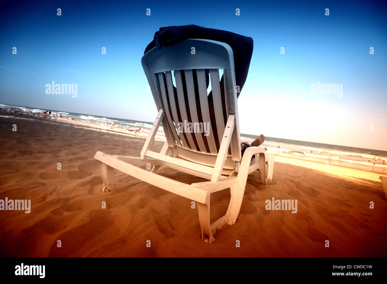 chair on sand and ocean background Stock Photo - Alamy