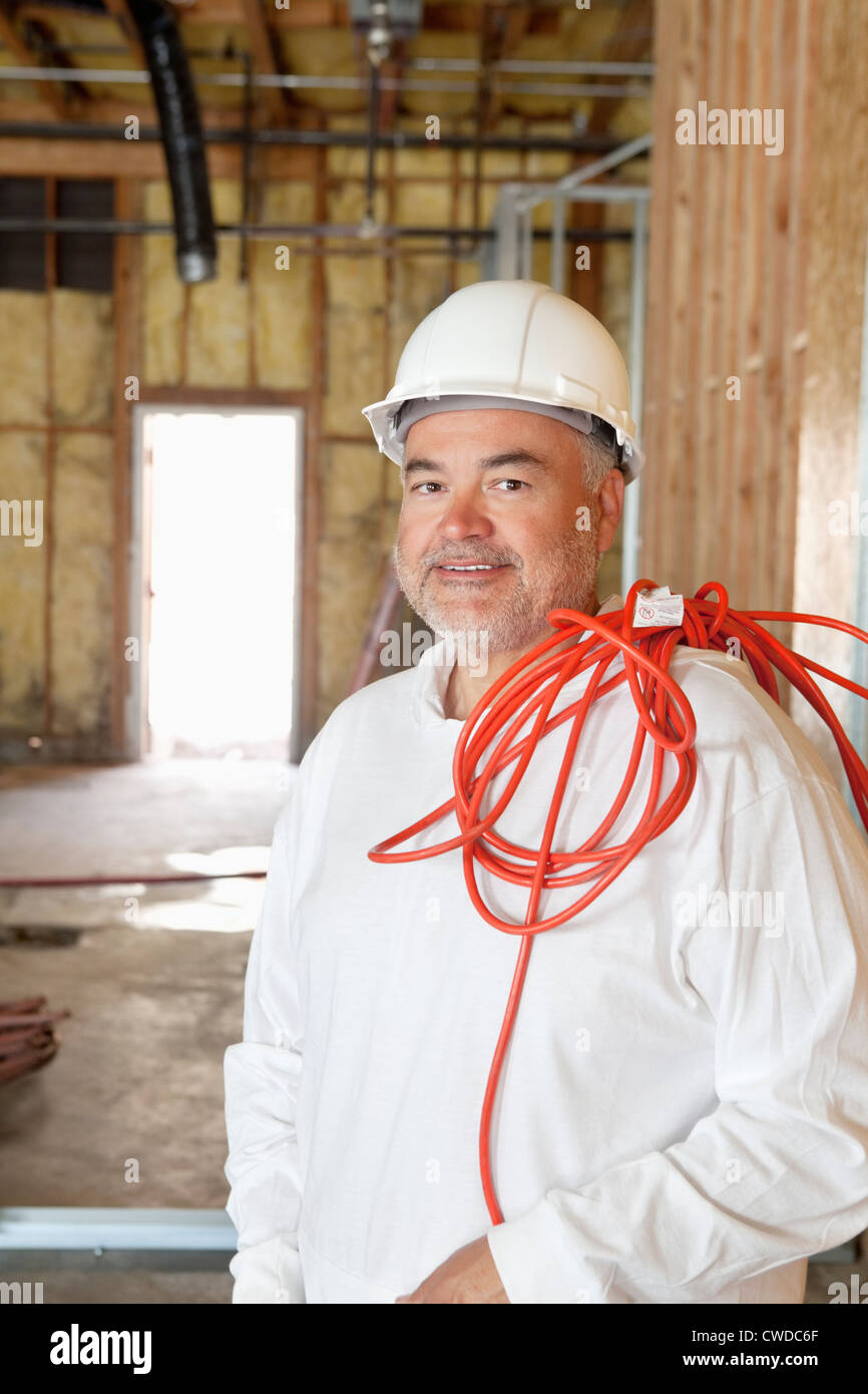 Portrait of a construction worker with a red electric wire Stock Photo ...