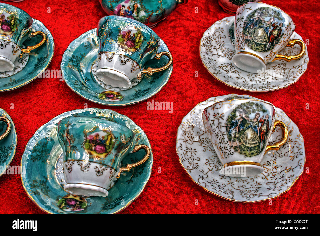 Old ceramic cups with paintings and gold applied Stock Photo - Alamy