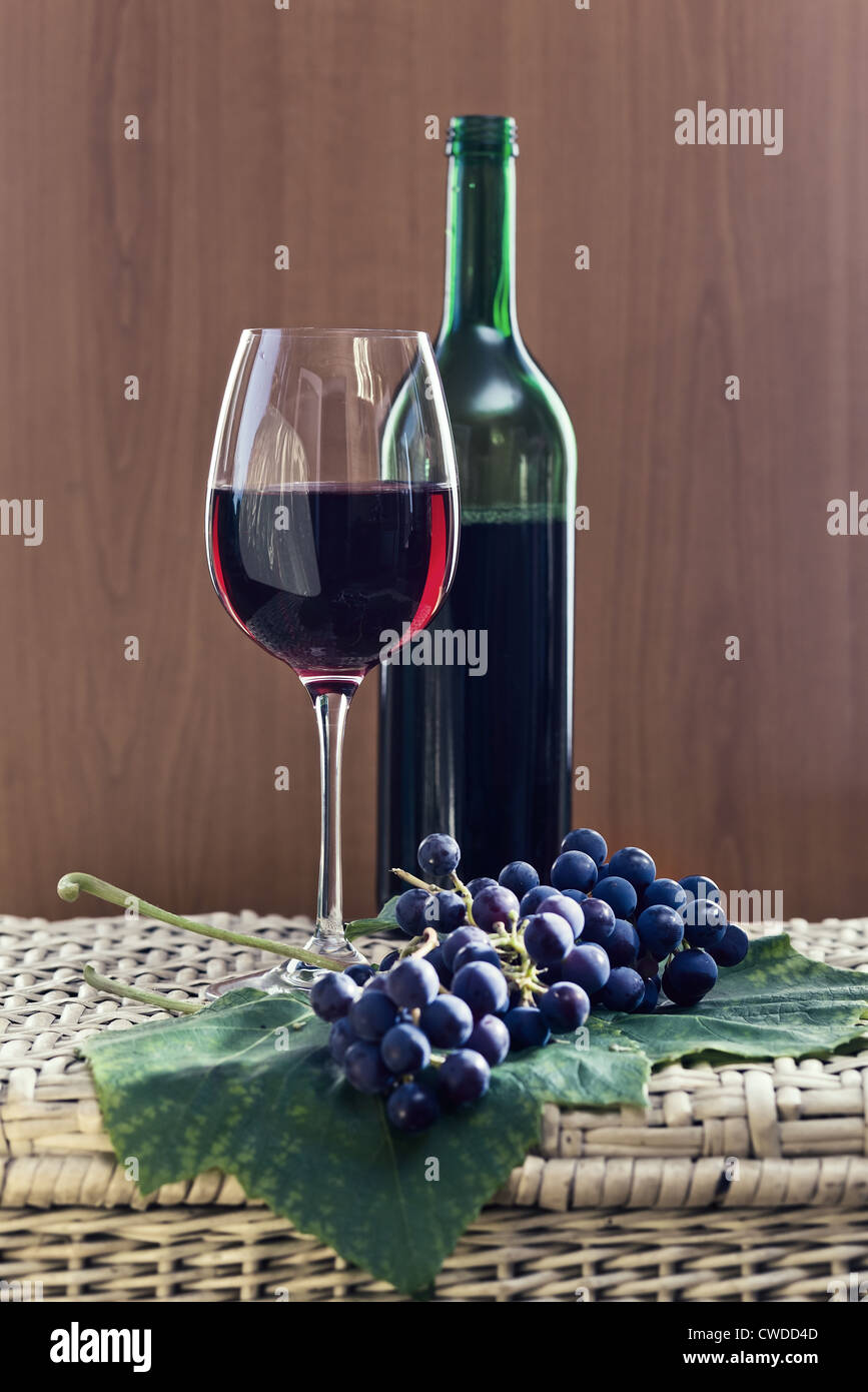 grape and red wine on a wattled table Stock Photo - Alamy