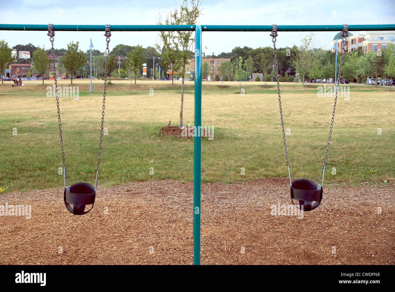 Swings in park hi-res stock photography and images - Alamy